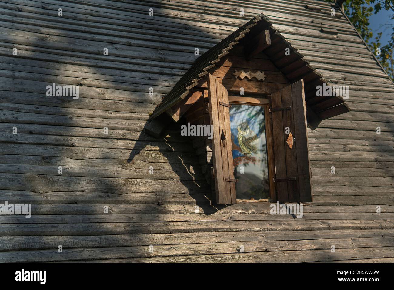 vintage shuttered window on the wooden roof of an old house Stock Photo ...
