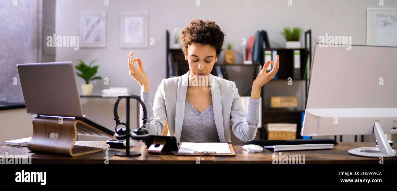 Yoga Meditation In Office. Business Woman Meditating Stock Photo - Alamy