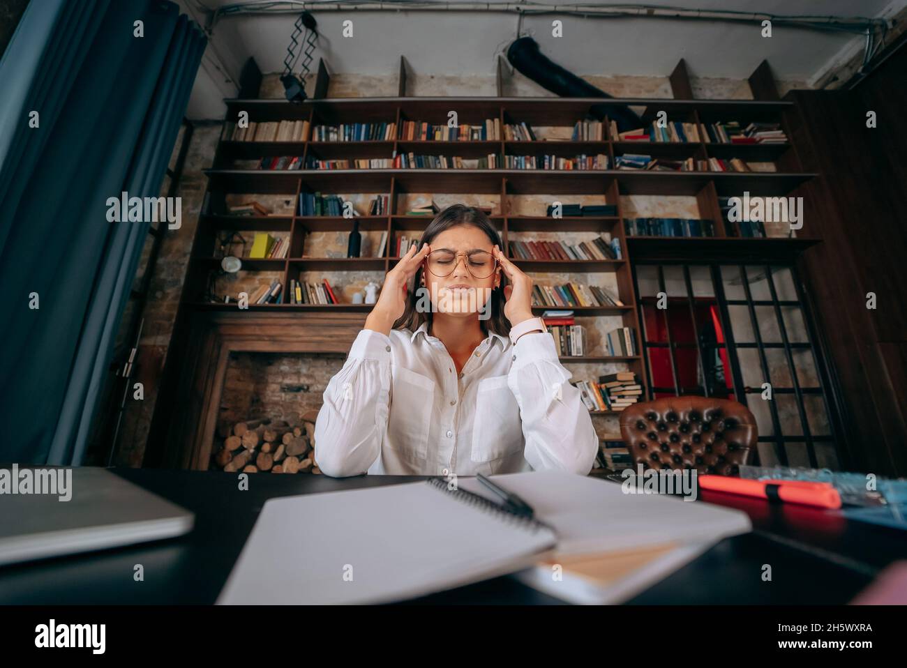 Young woman in office thinking over problem on background of ...