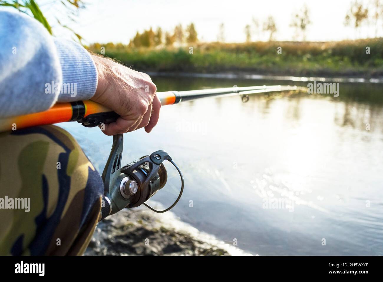 Fishermans hands hold fishing rod hi-res stock photography and images ...