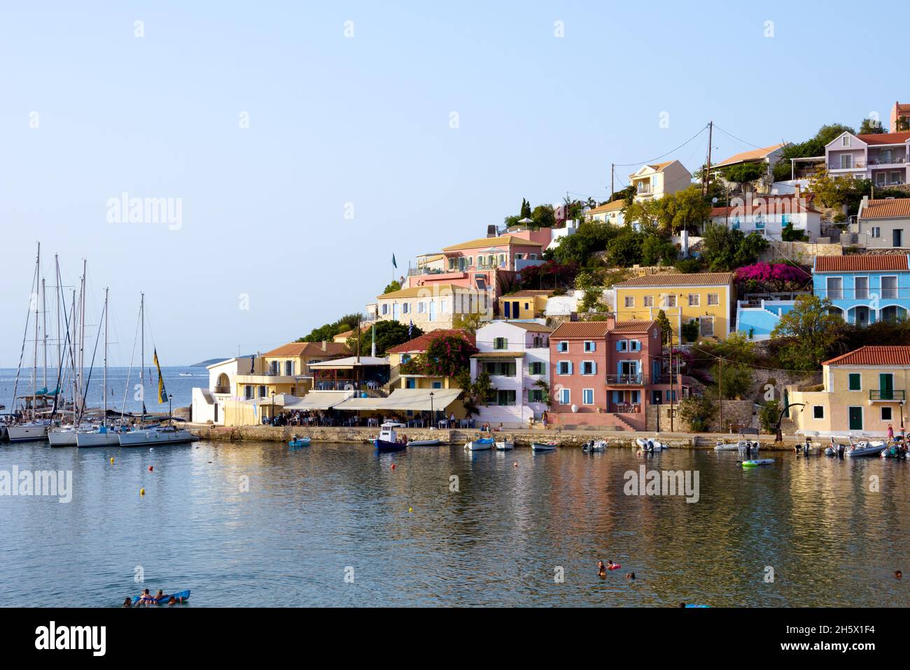 Boats and colored houses in Assos village, Kefalonia, Greece Stock ...
