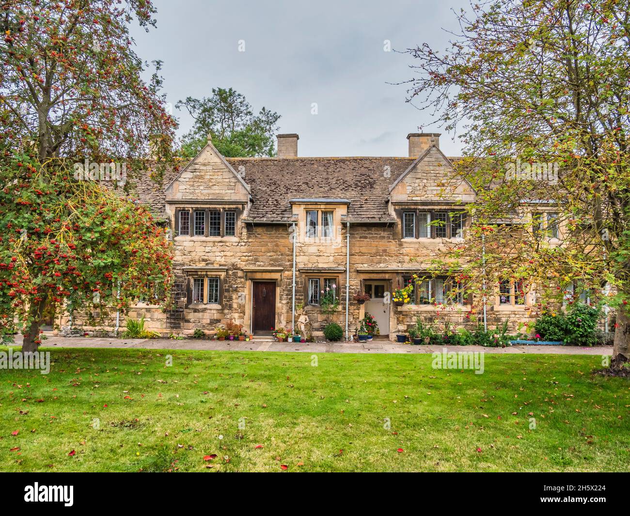 Colourful street scene of the buff stone buildings of the Burghley Alm ...