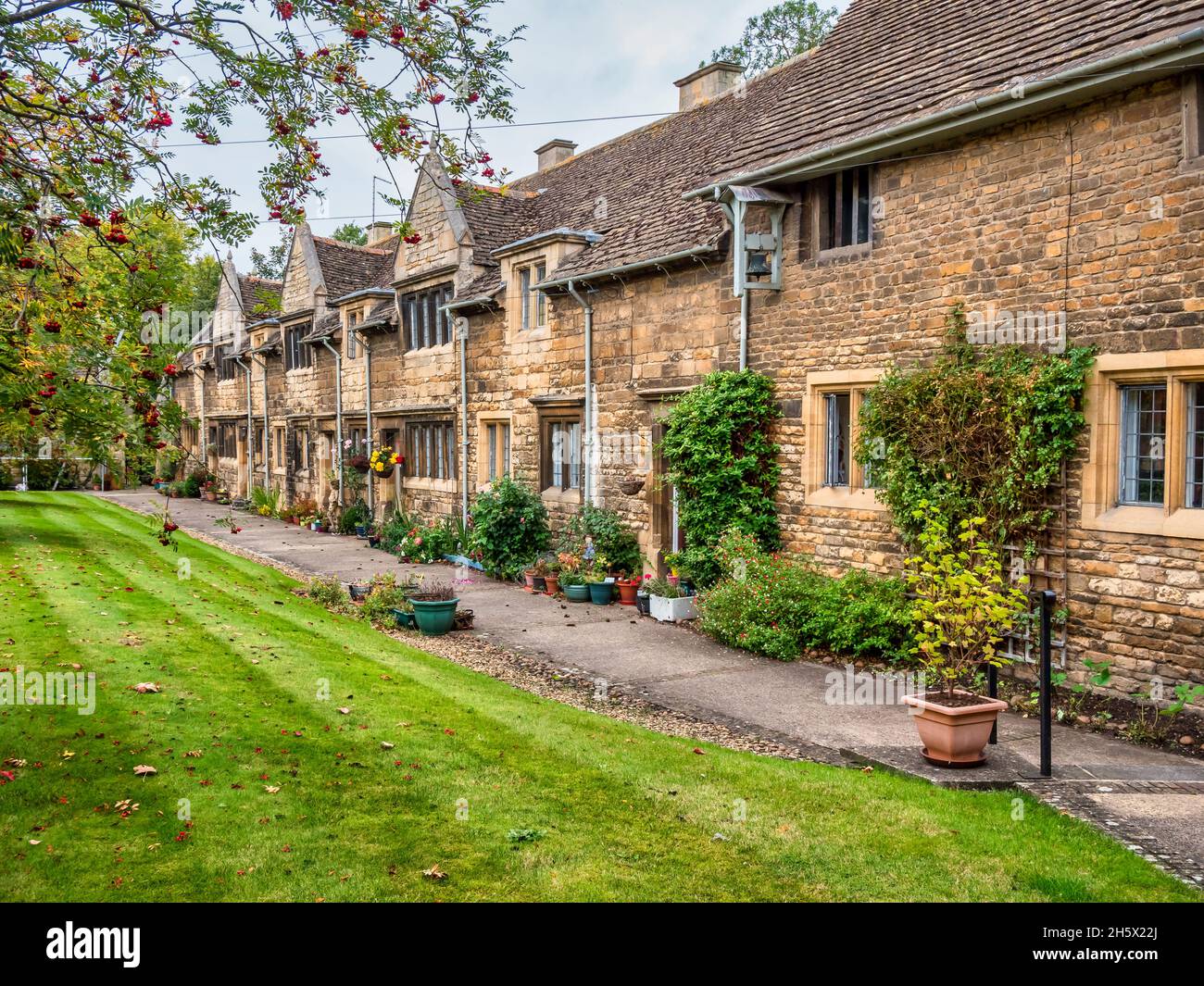 Colourful street scene of the buff stone buildings of the Burghley Alm ...