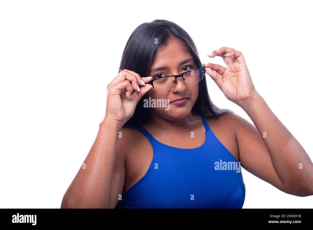 Black skinned latin woman lowers her glasses with accepting expression ...