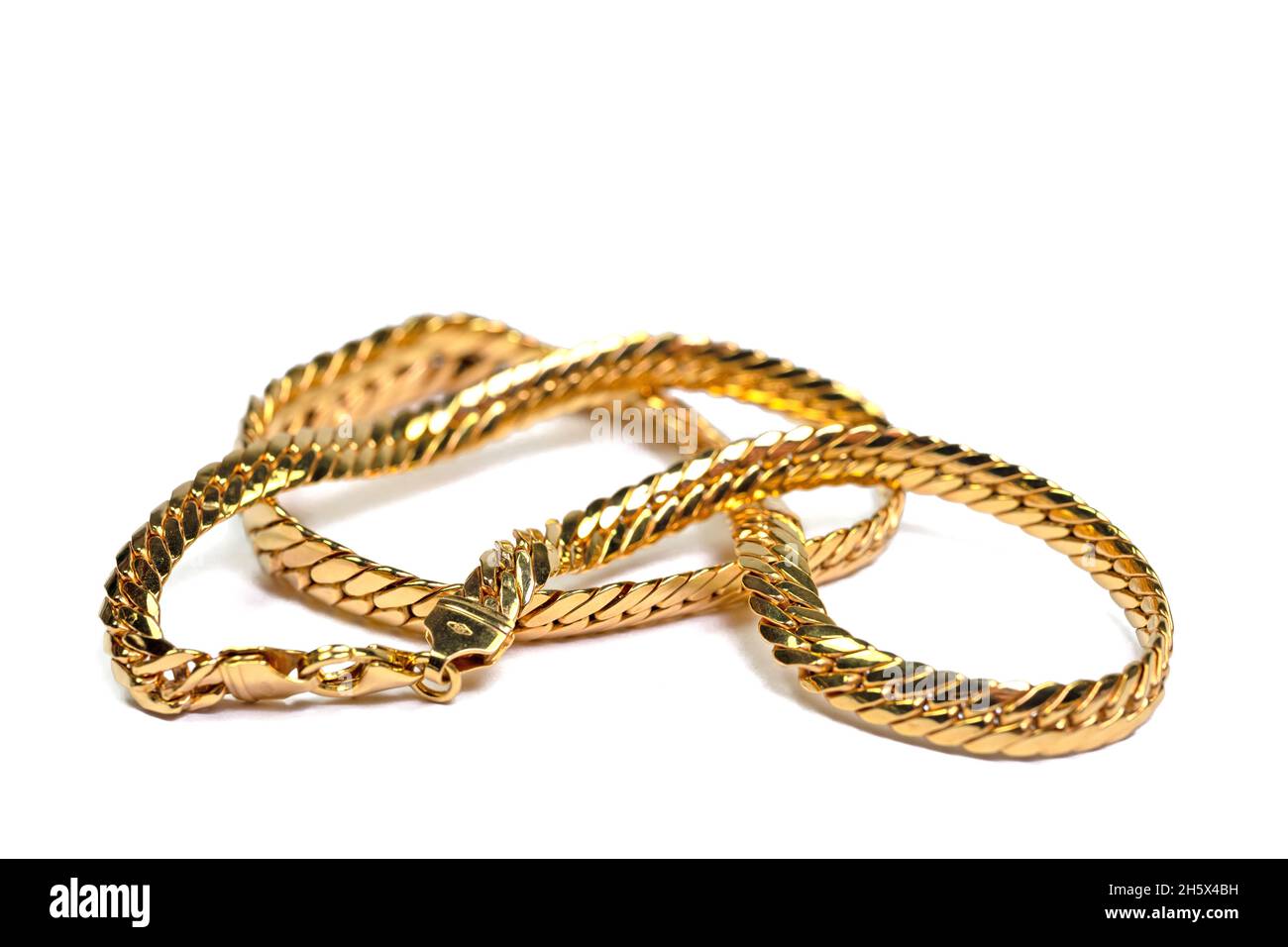 Gold chain isolated against a white background Stock Photo - Alamy