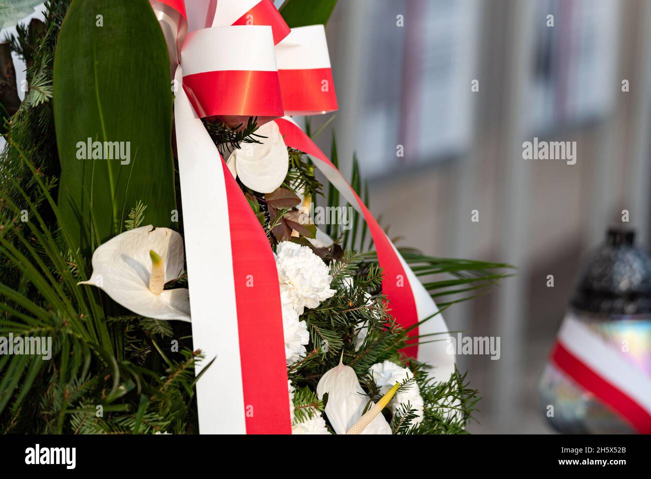 White and red flowers with a ribbon in Polish national colors. National ...