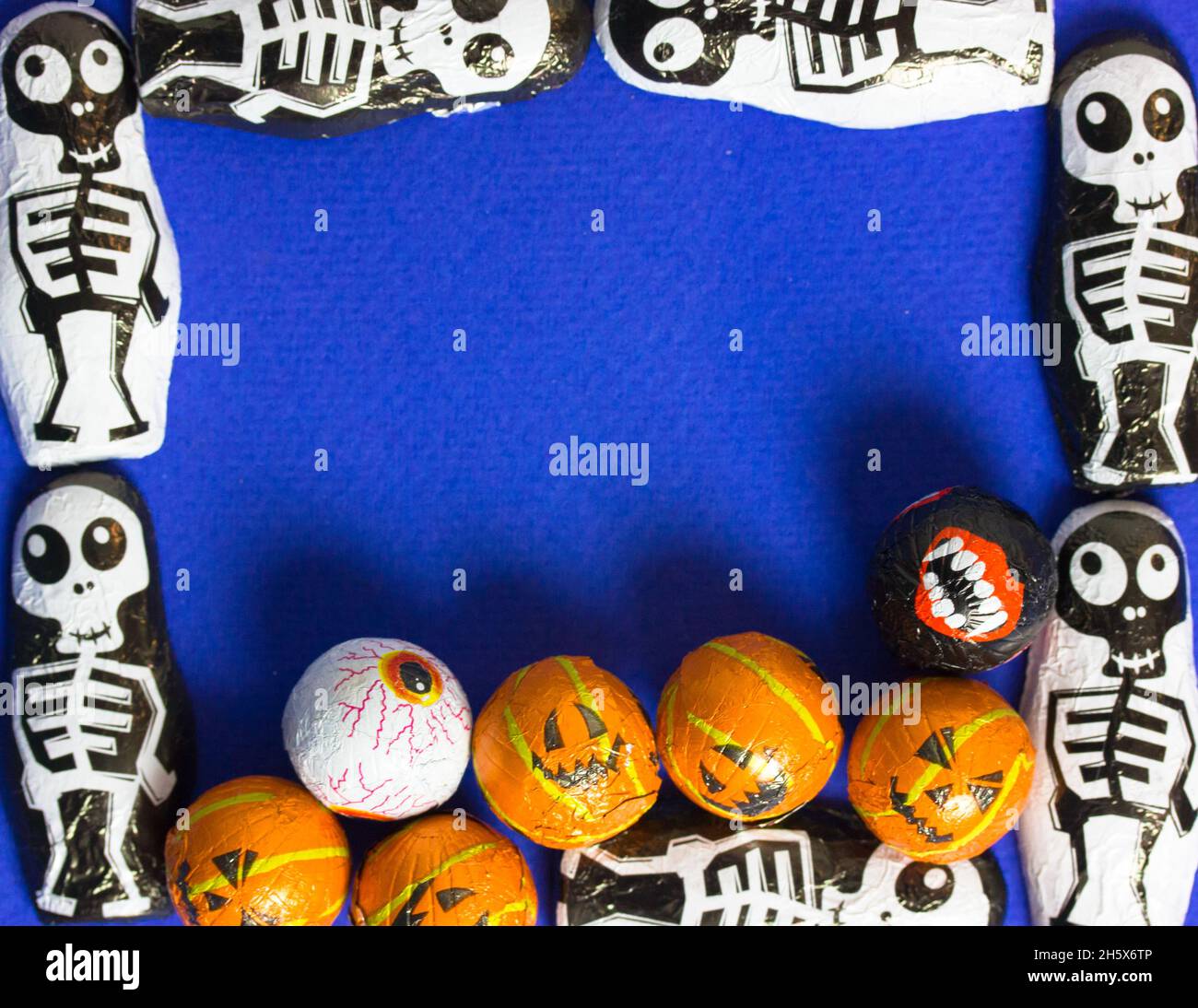 Creative Halloween frame with skeletons, jack o lantern pumpkins with ...