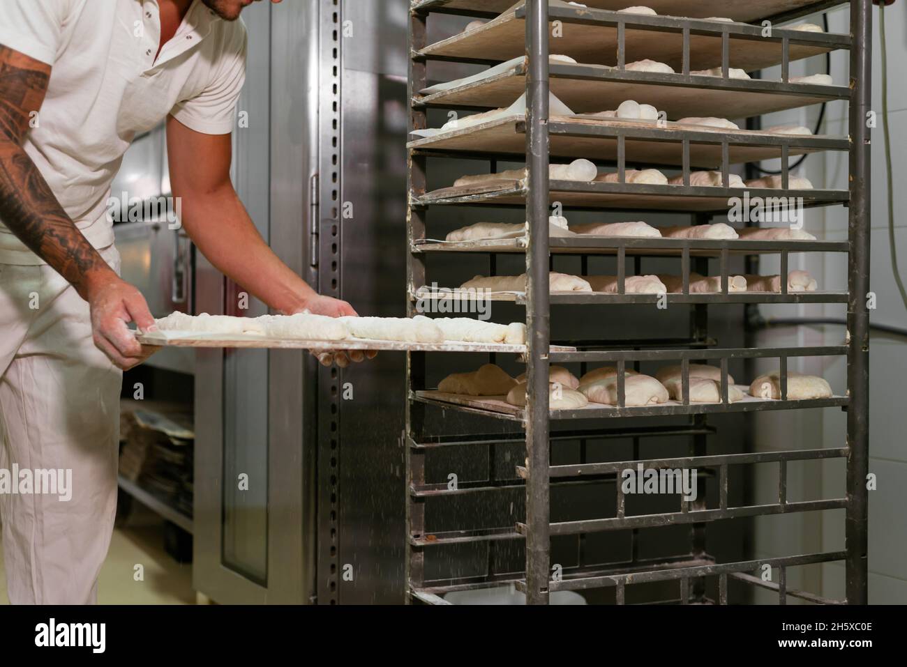 Unrecognizable man putting bread dough hi-res stock photography and ...