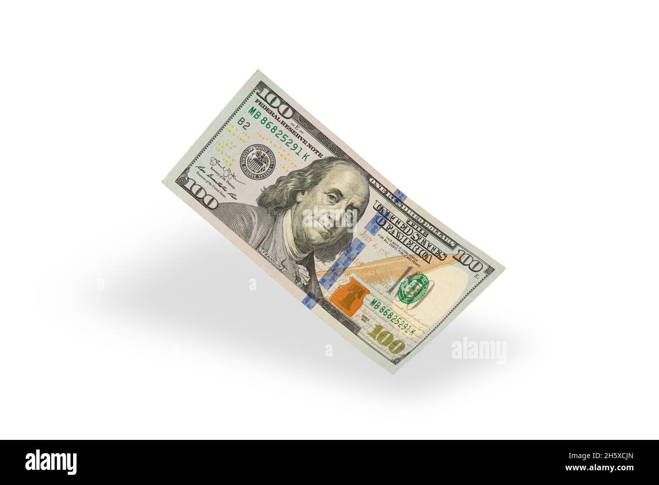 Hundred dollar bill falling casting shadow, half-folded bill close-up ...