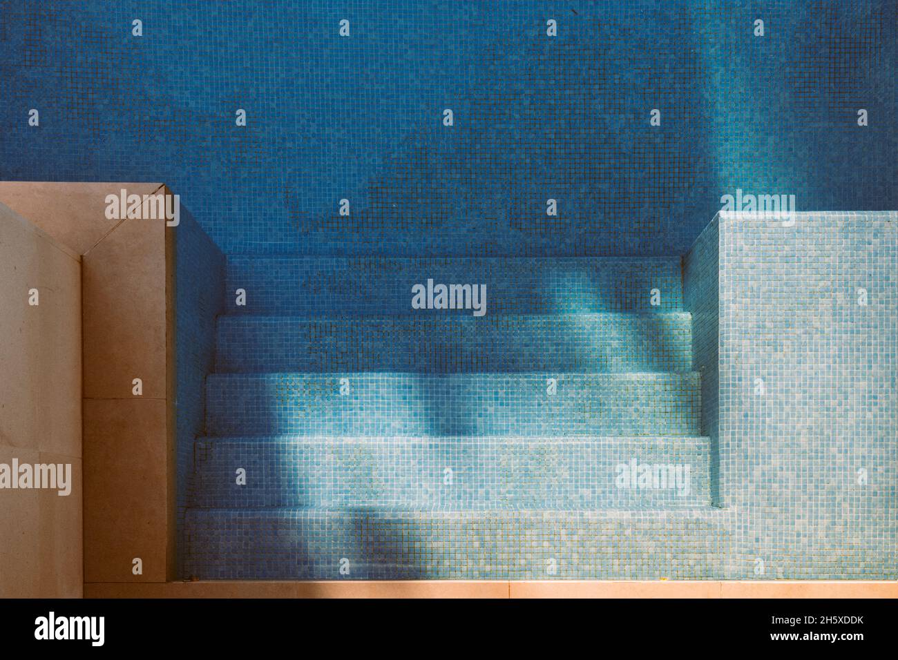Top view of tiled bottom and steps in swimming pool with clean blue ...
