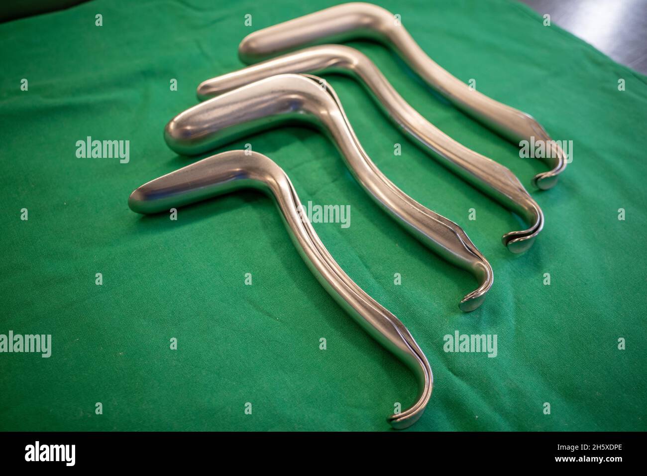 various specula are placed on an operating table for performing a ...