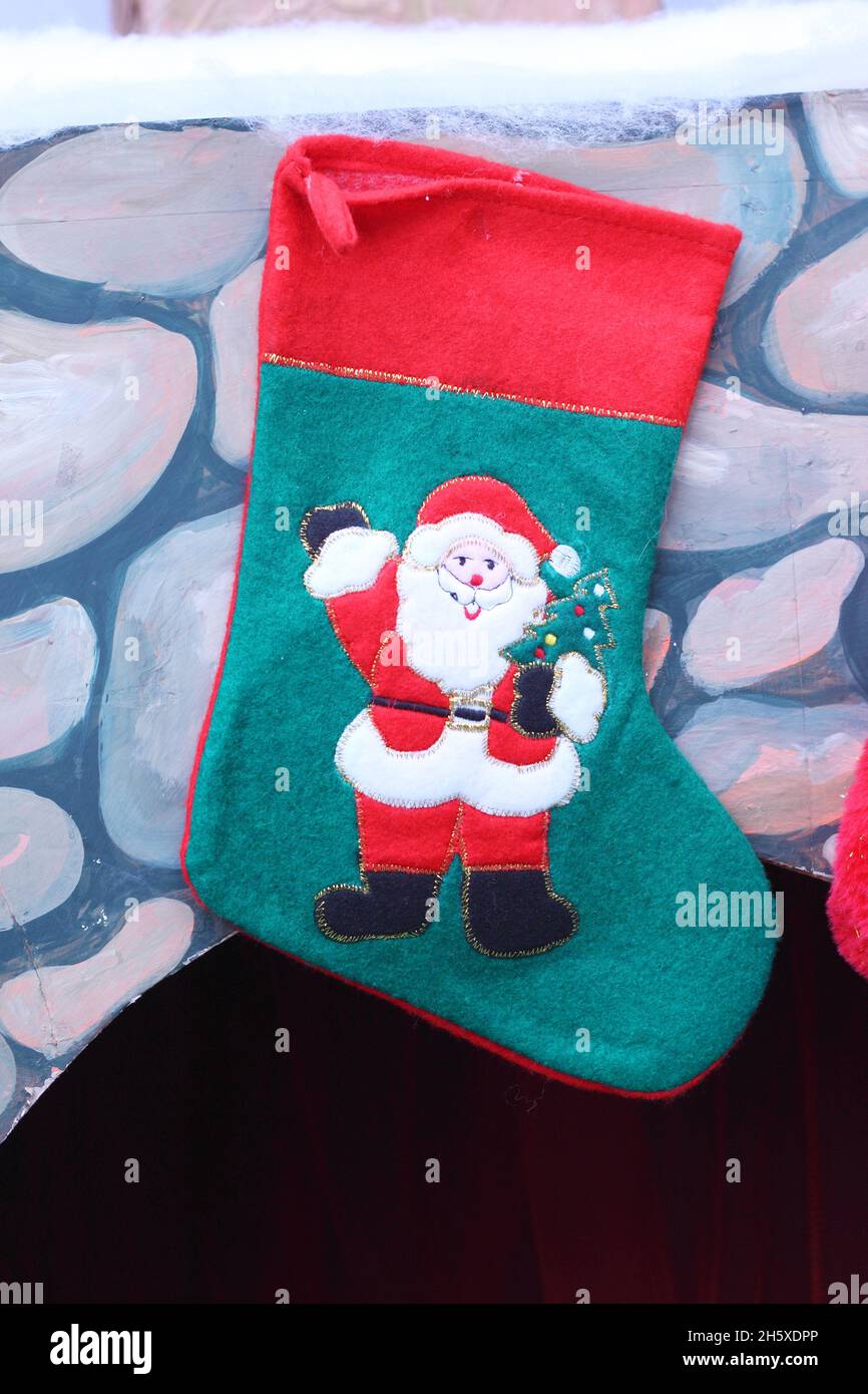 Christmas boot for the gifts hanging on the wall Stock Photo - Alamy