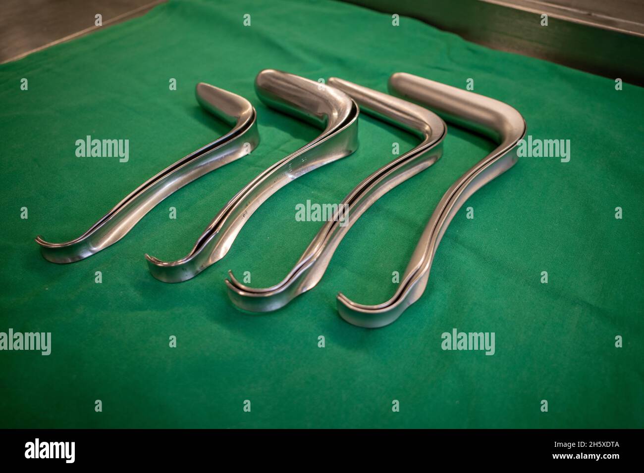 various specula are placed on an operating table for performing a ...