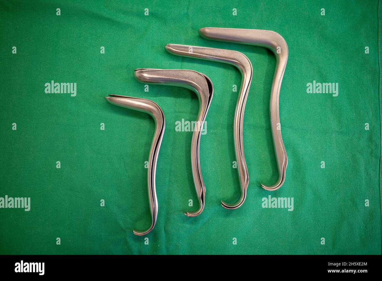 various specula are placed on an operating table for performing a ...