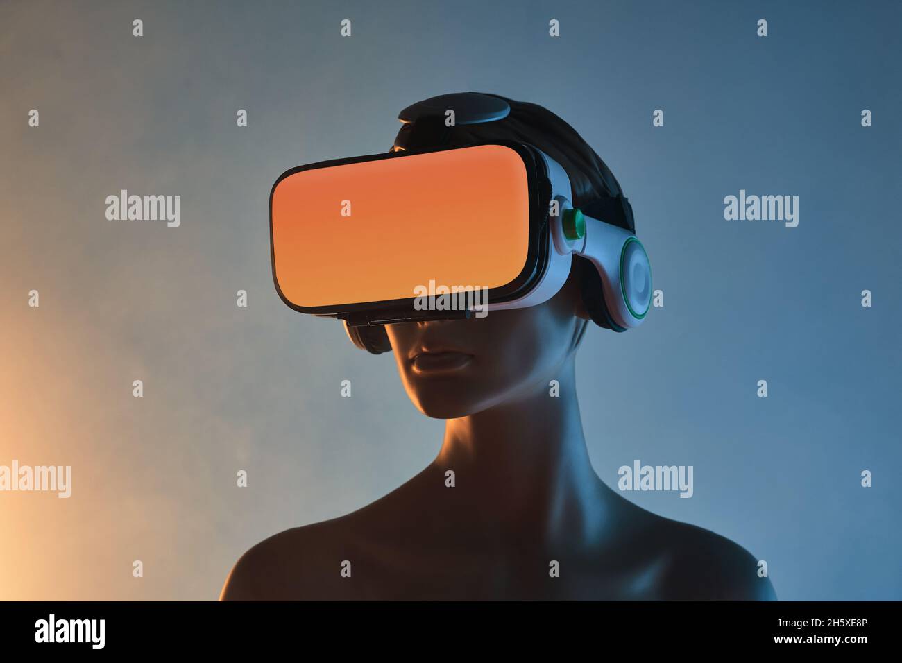 Female dummy with VR goggles placed against bright blue background as ...