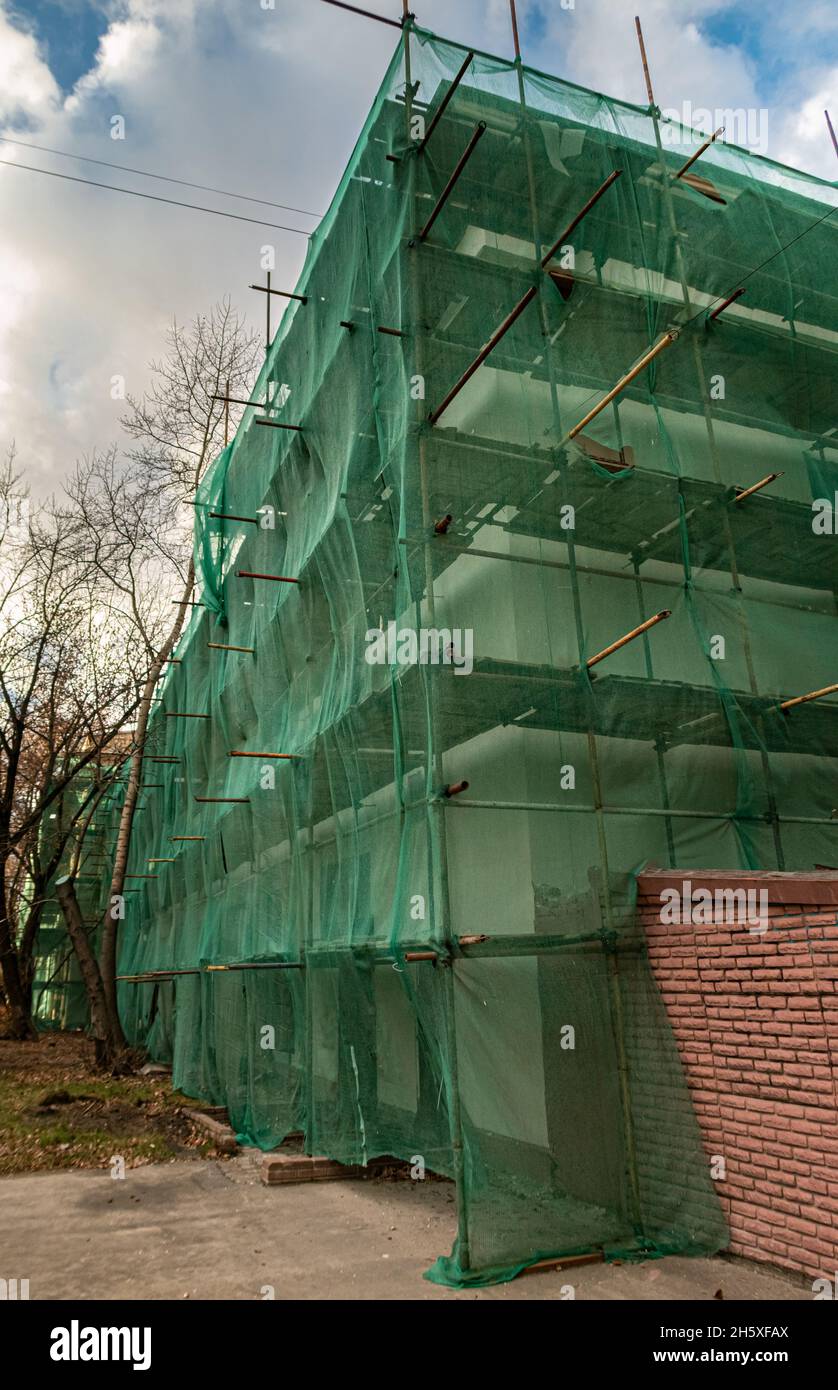 building under reconstruction covered with a grid. High quality photo ...