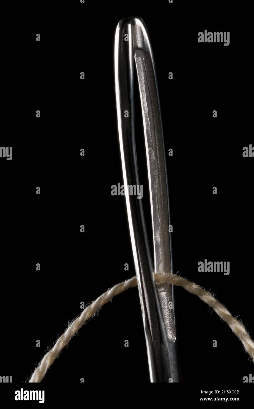 Sewing needle and thread, low key isolated Stock Photo - Alamy