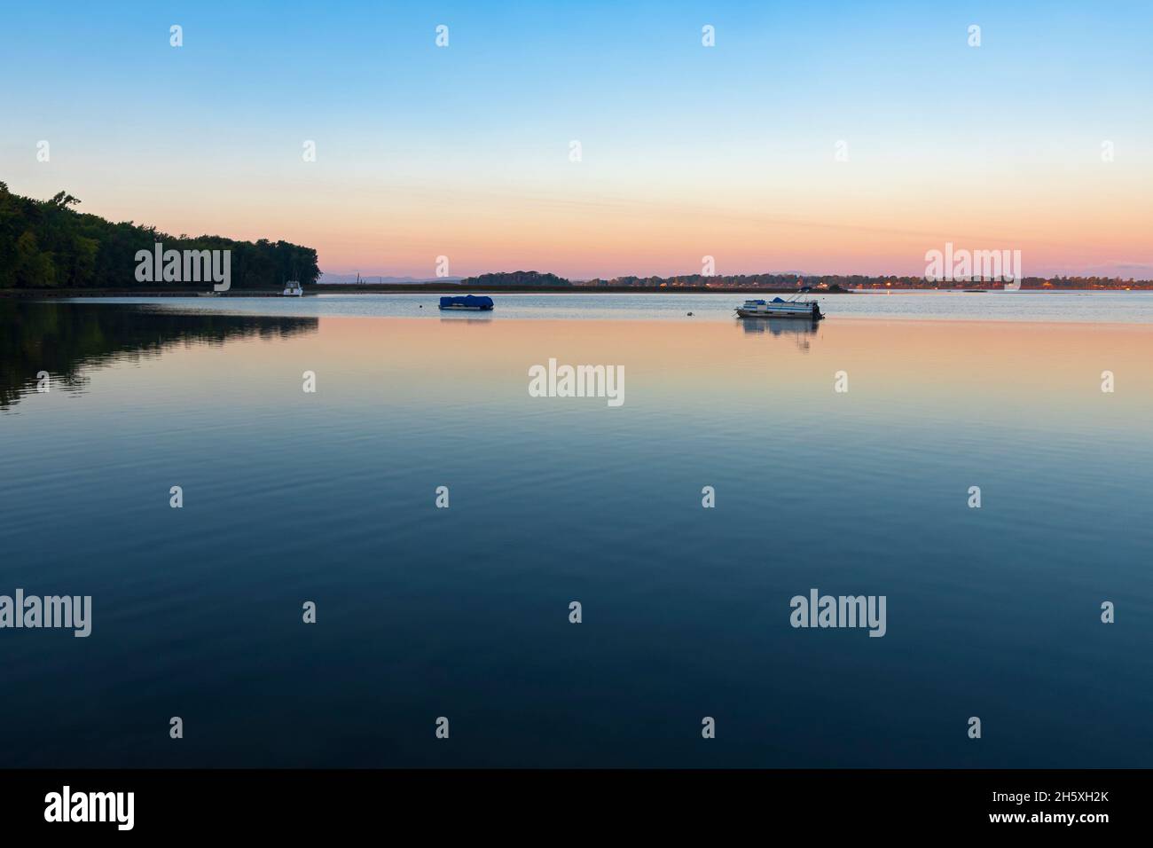 dawn illuminates waters of lake champlain at saint albans bay in ...