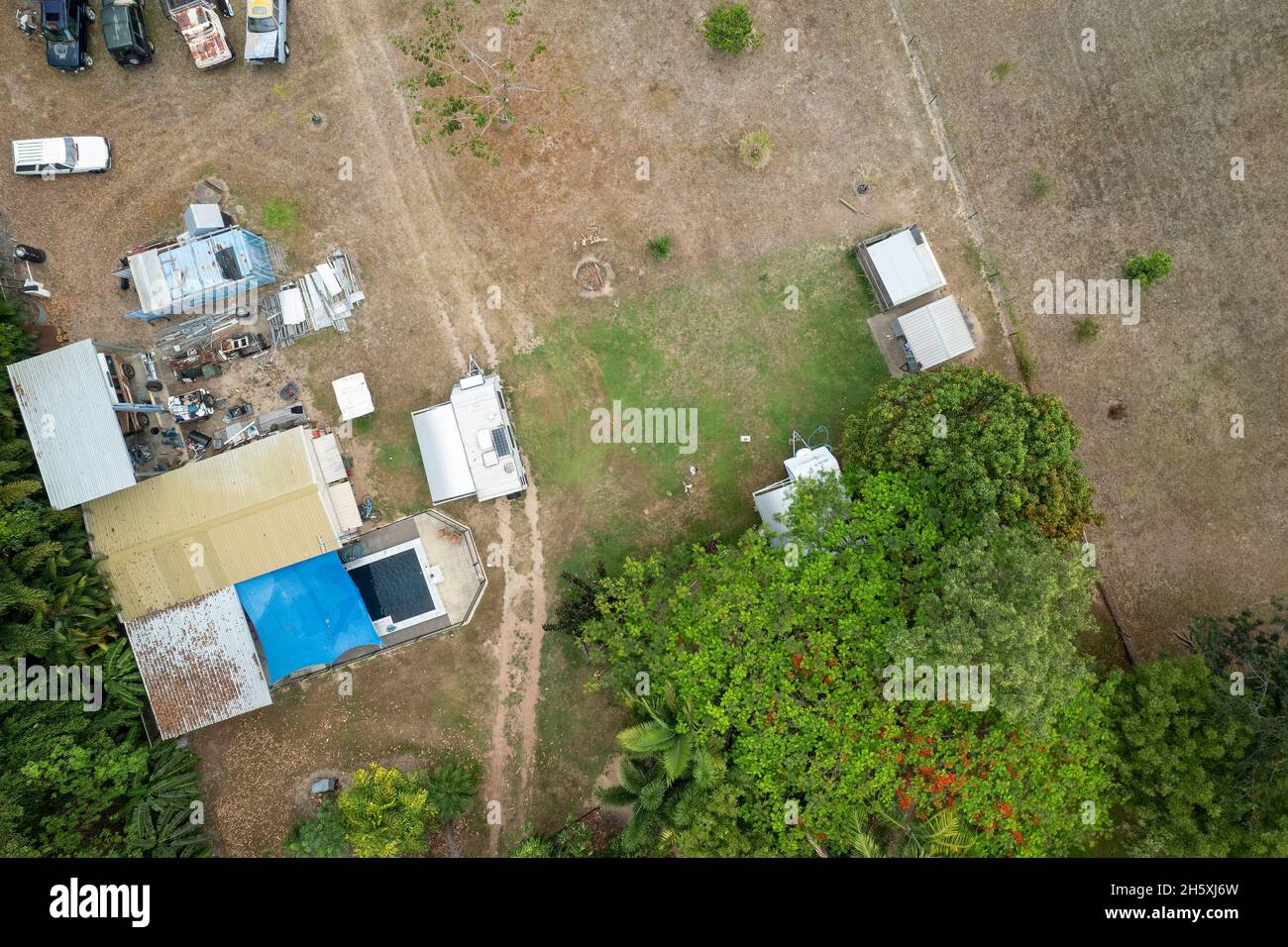 Birds eye view of a shed with junk behind it and a swimming pool in ...