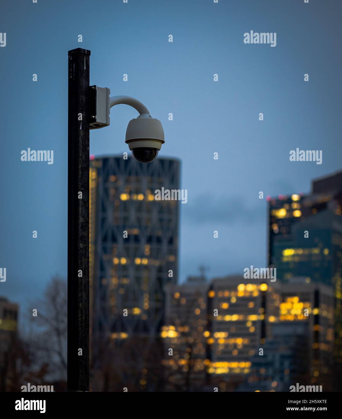 Surveillance camera on a post overseeing the activity in a private ...