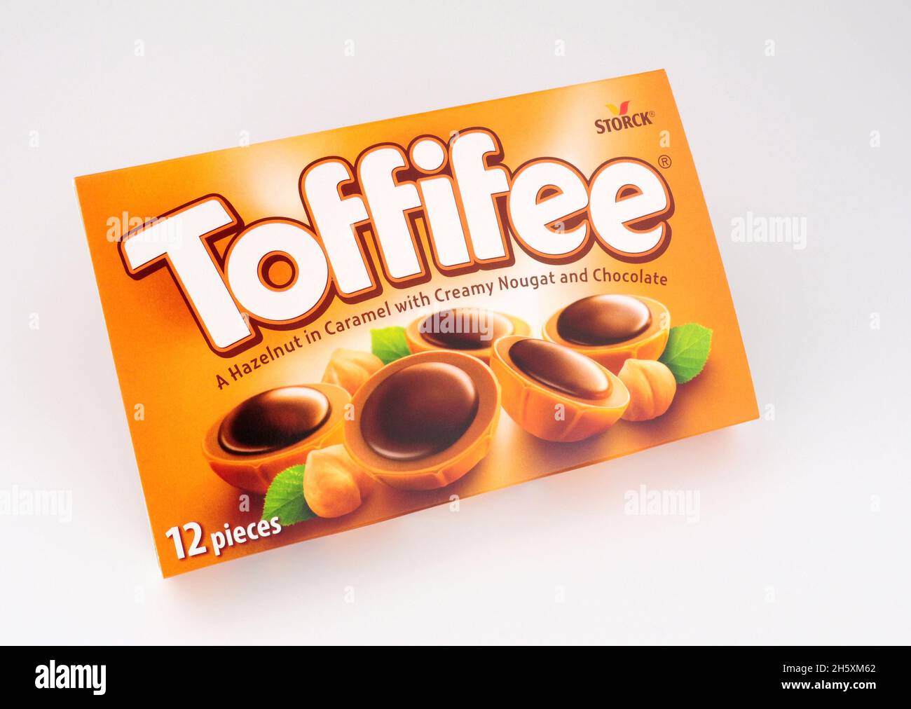 Box of Toffifee hazelnut and caramel candy cups topped with chocolate ...