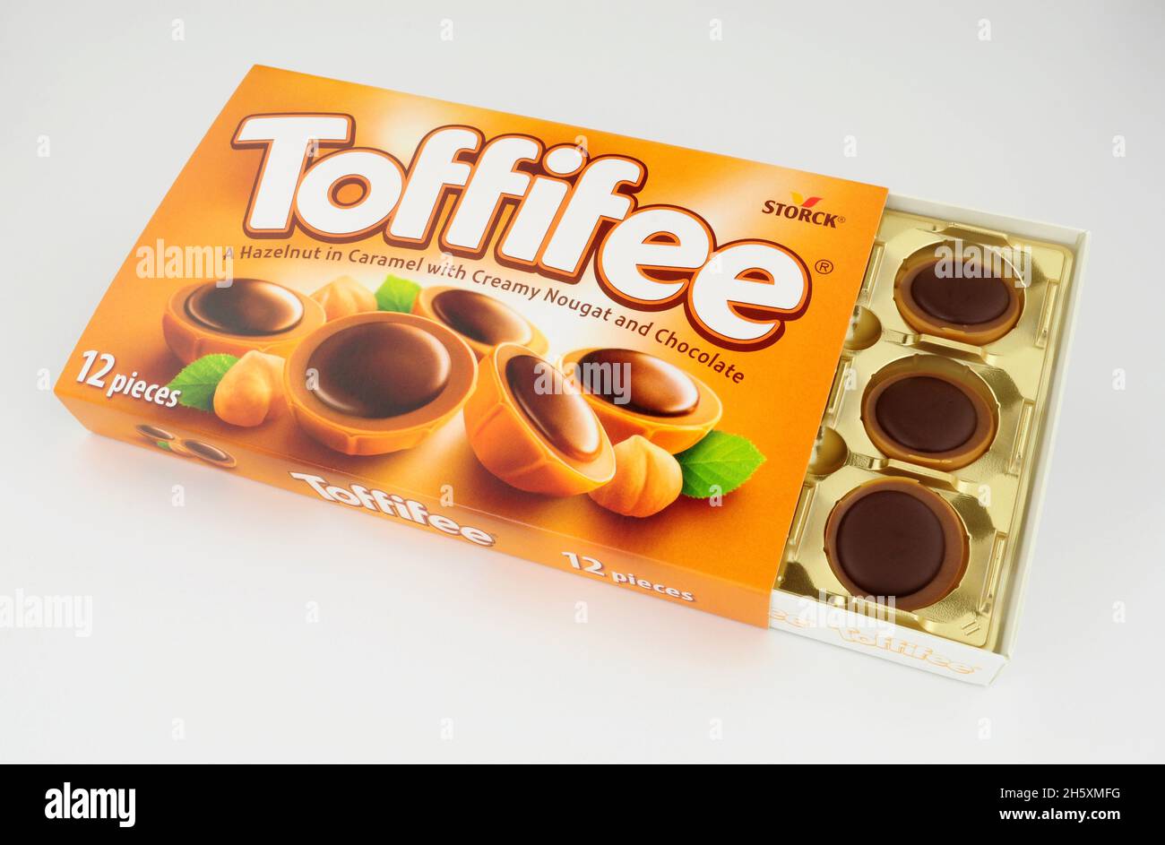 Box of Toffifee hazelnut and caramel candy cups topped with chocolate ...