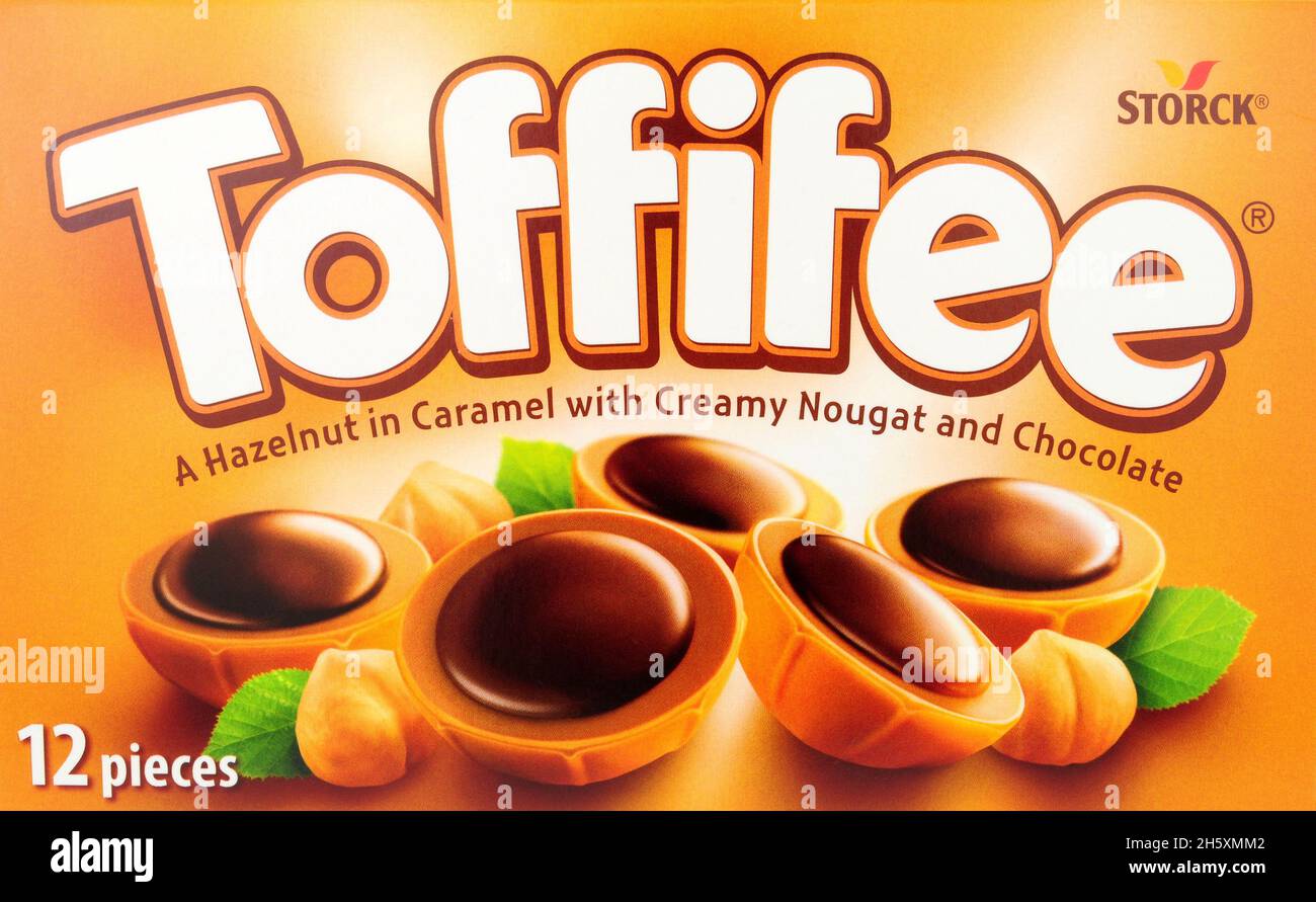 Box of Toffifee hazelnut and caramel candy cups topped with chocolate ...