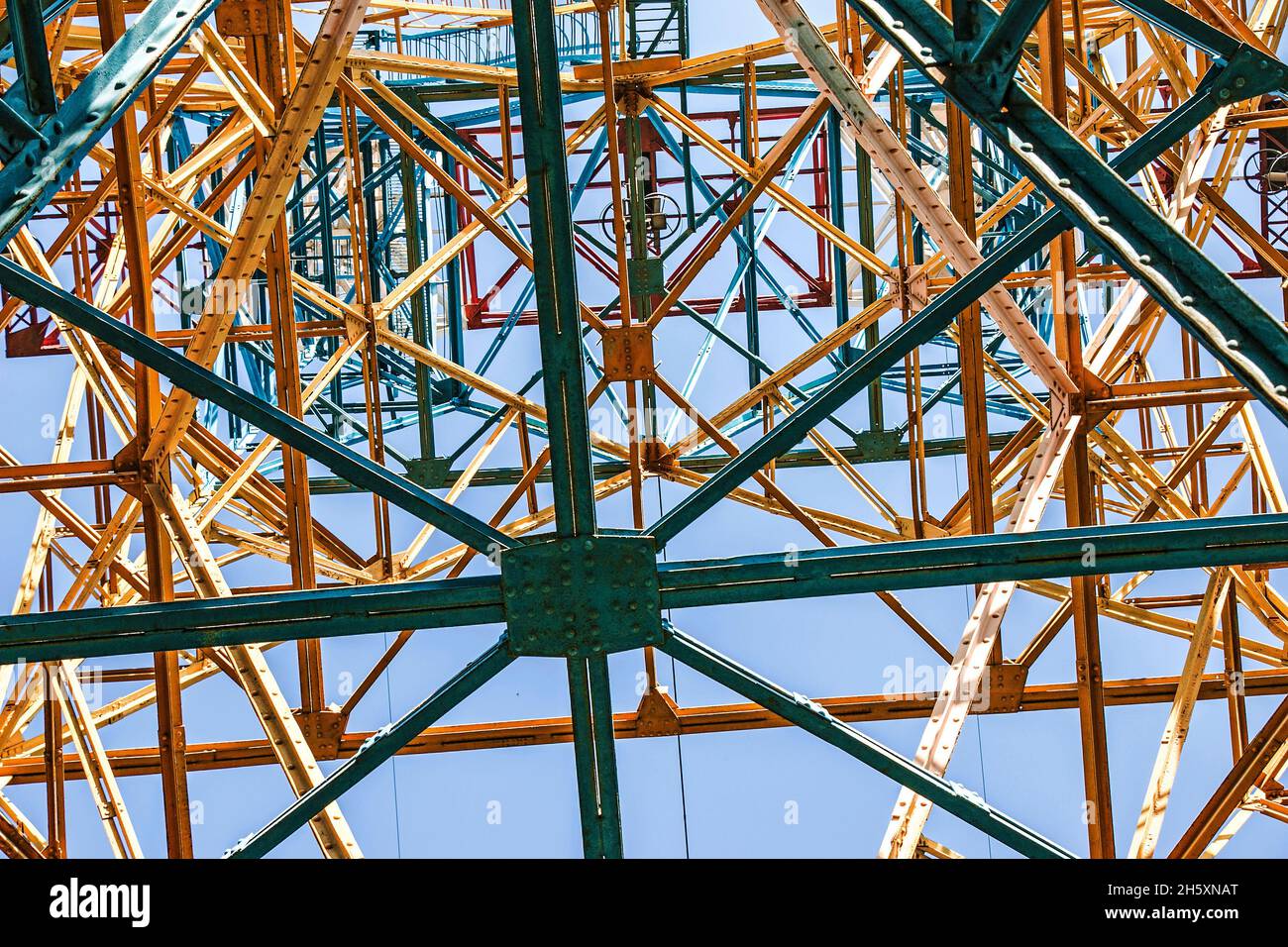 Silhouette of a power line pylon against the blue sky. Transmission of ...