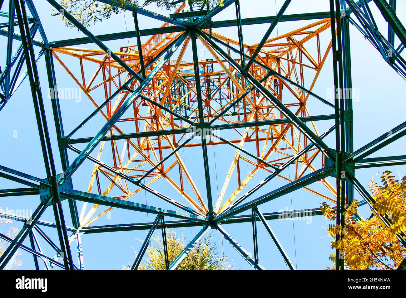 Silhouette of a power line pylon against the blue sky. Transmission of ...