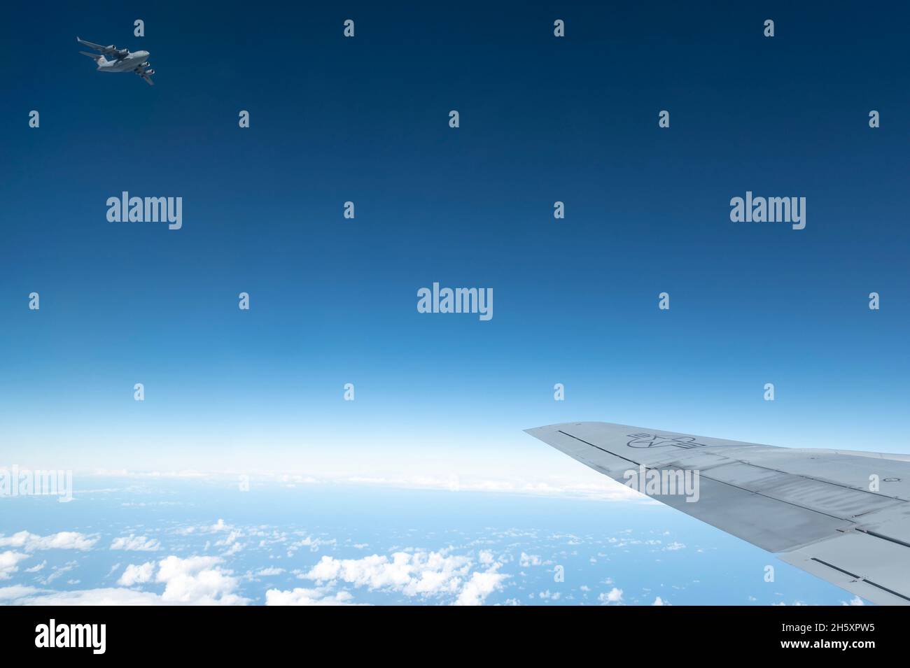A C-17 Globemaster III soars to the left of a KC-135 Stratotanker Nov ...