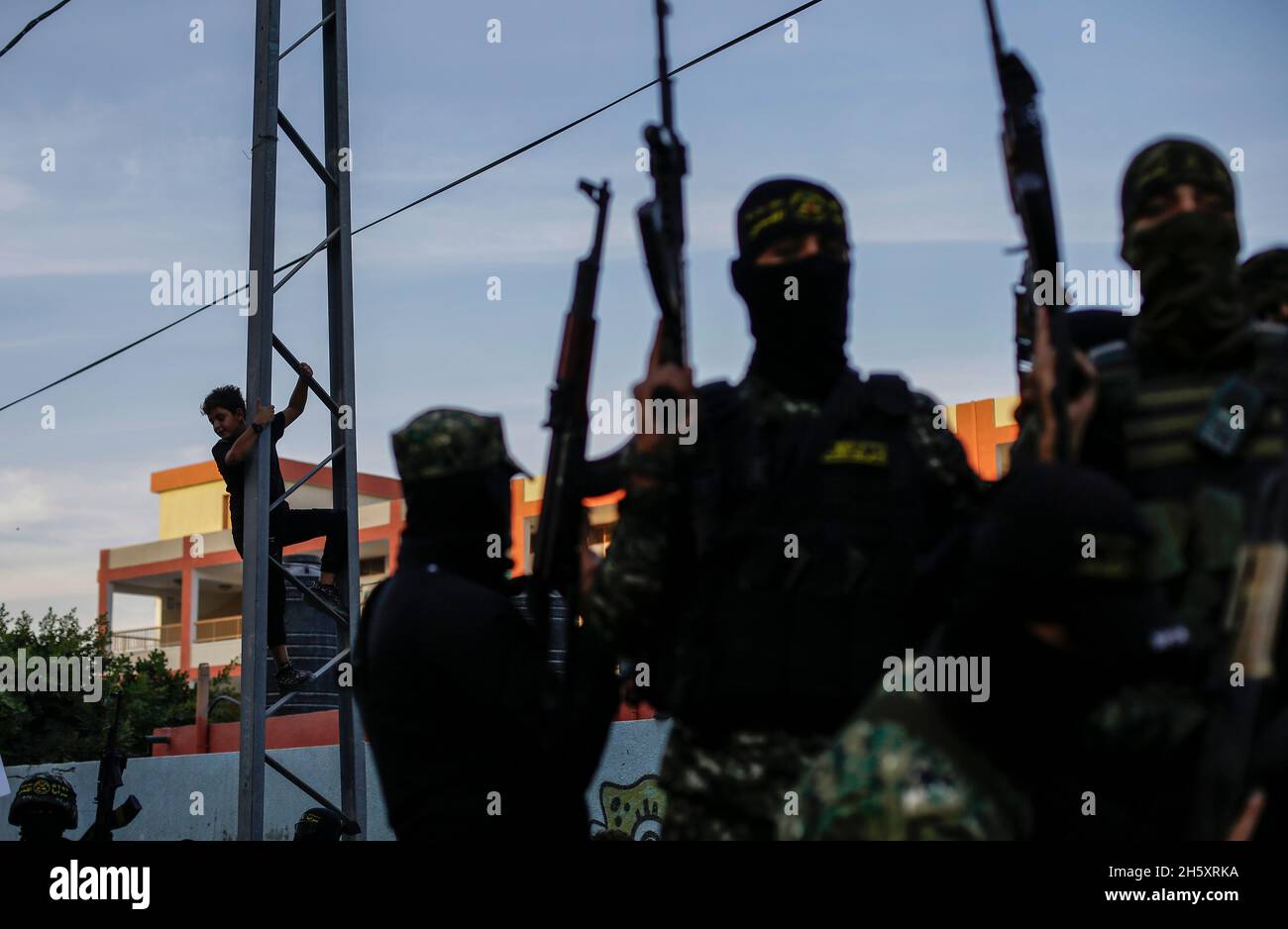 A Palestinian child seen watching the military parade. Activists from ...