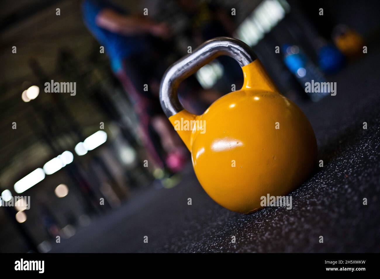 yellow Kettlebell on the gym floor Stock Photo - Alamy