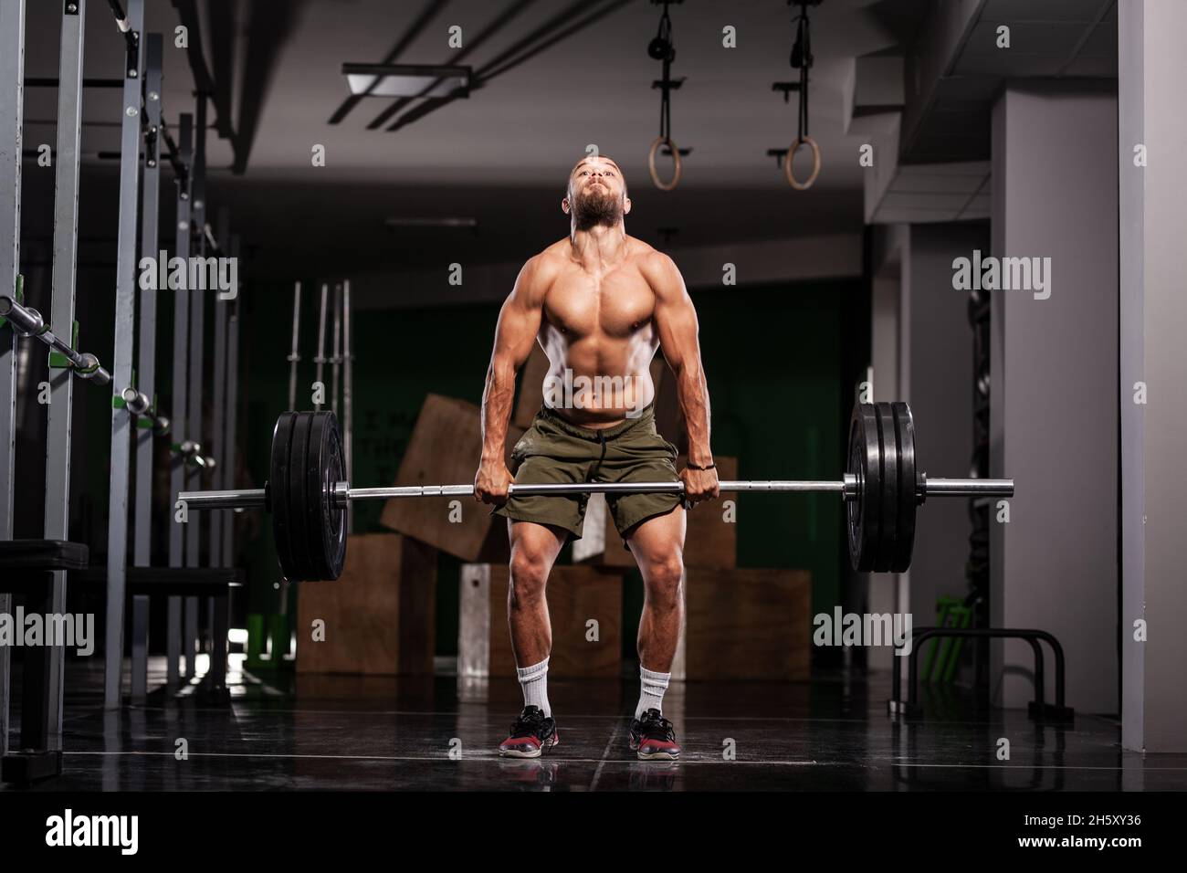 Muscular athlete lifting very heavy barbell Stock Photo - Alamy