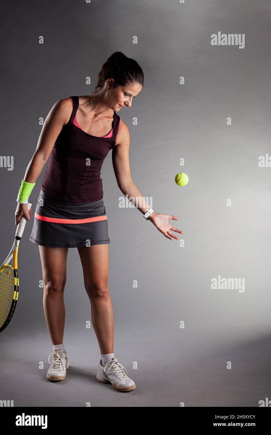 Professional female tennis player. Girl swinging racket preparing to ...