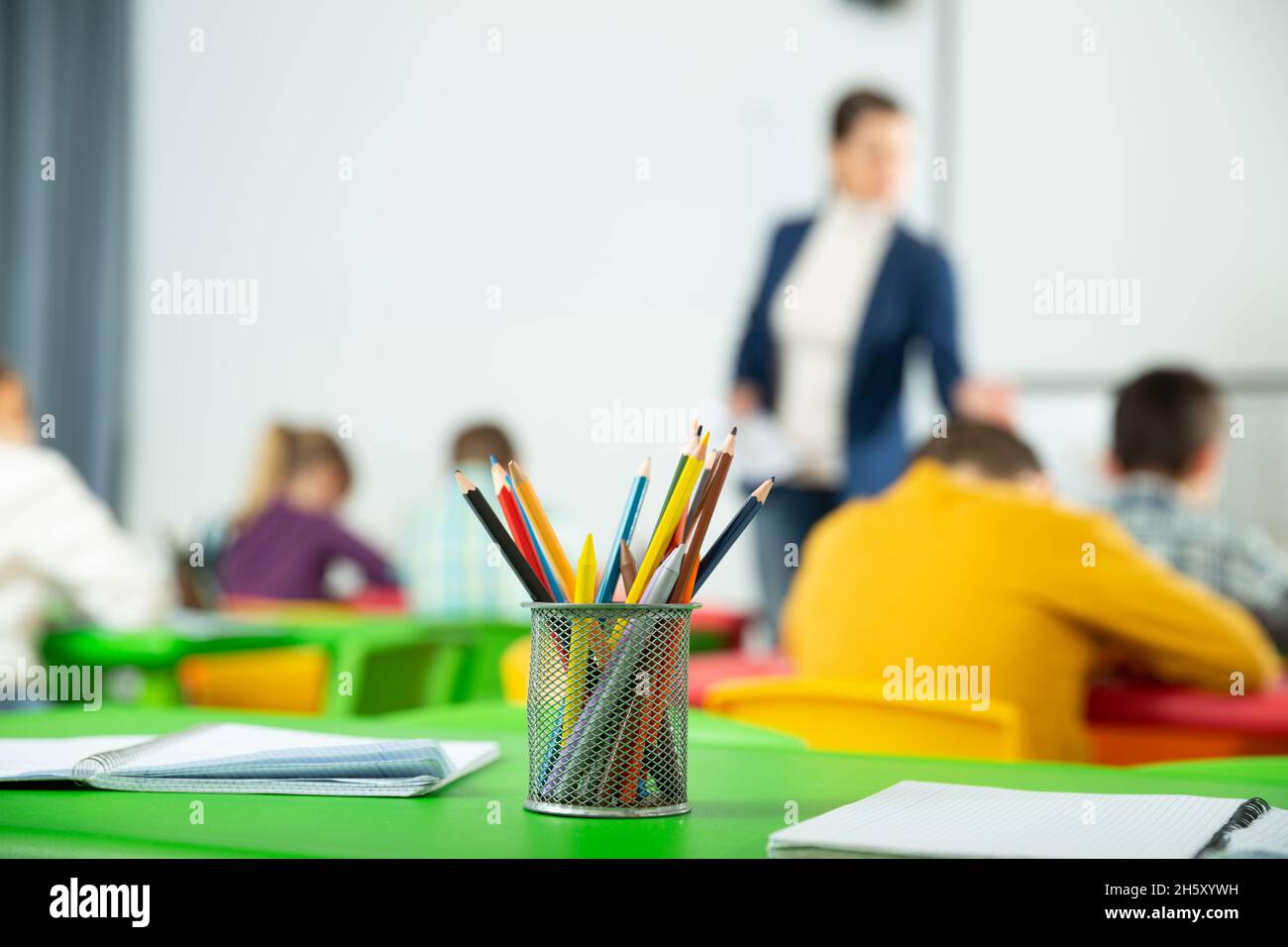 Pencils and notebooks on blurred background of elementary school ...