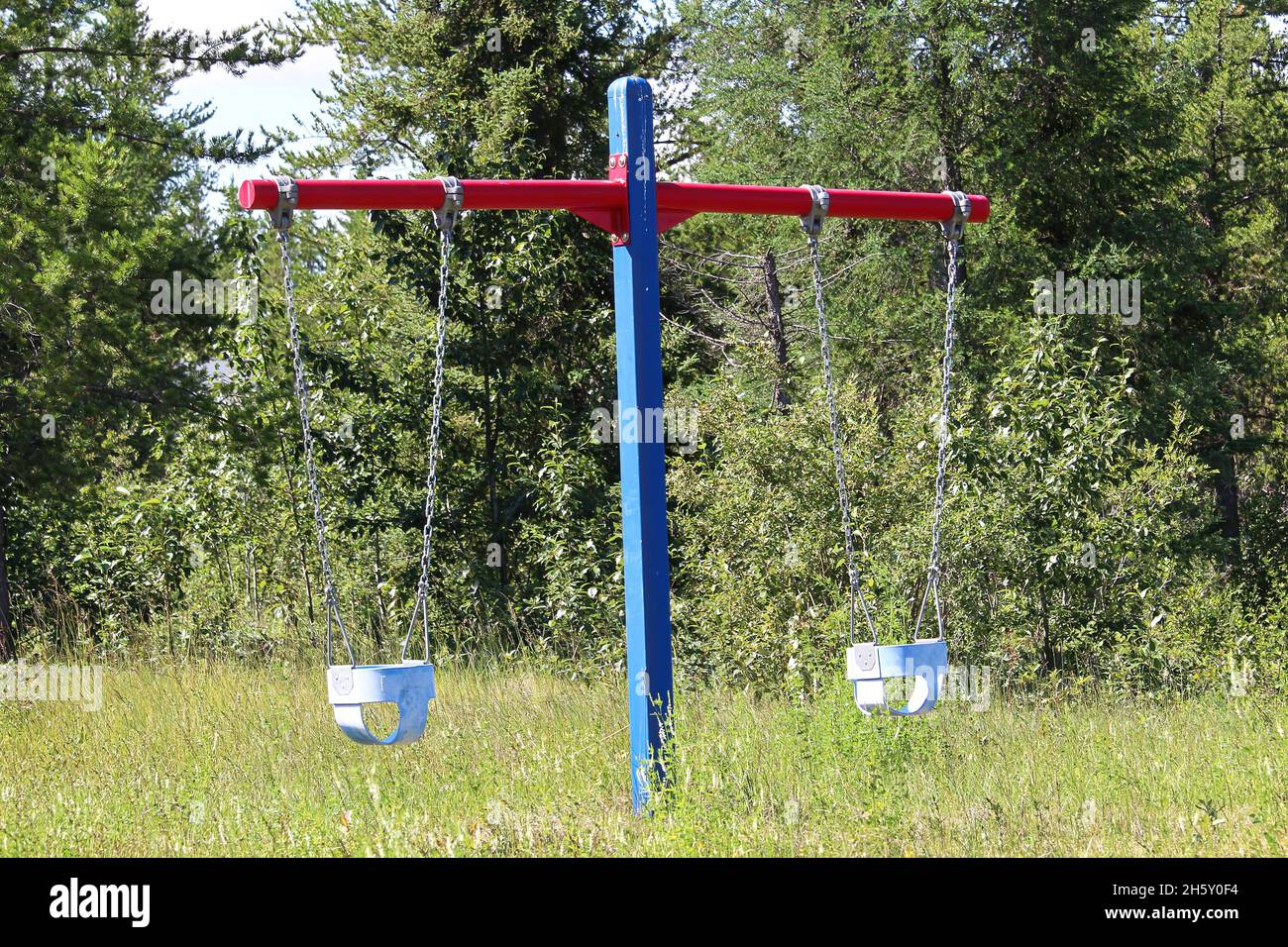 A view of baby swings in a playground Stock Photo - Alamy
