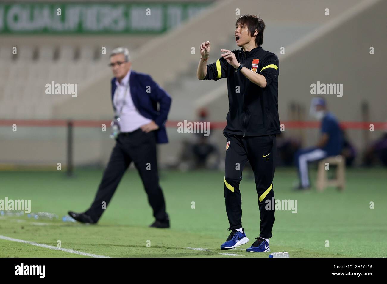 Sharjah, UAE. 12th Nov, 2021. Head coach Li Tie (R) of China gestures ...
