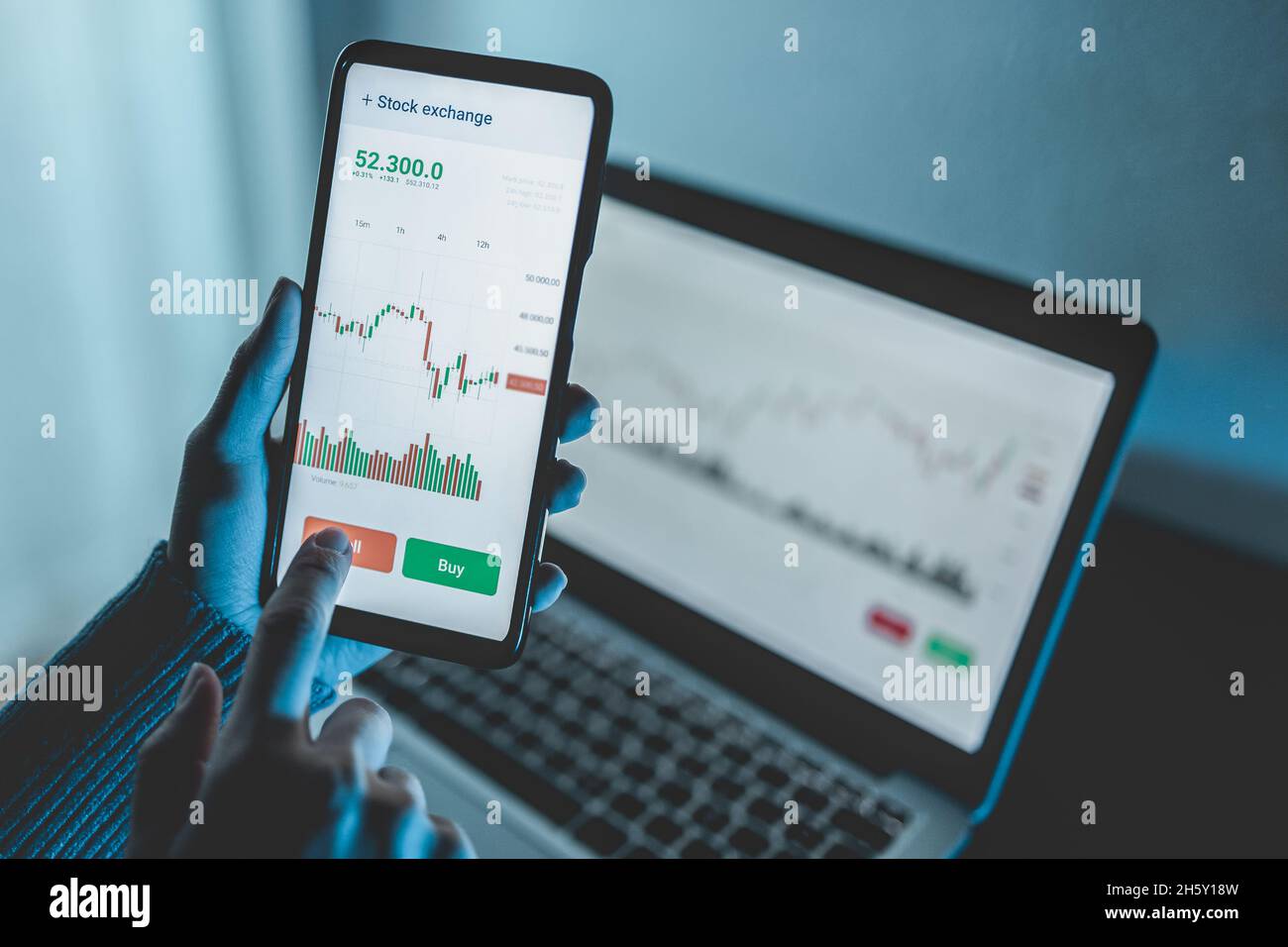 Trader using stock exchange app online for trading operations in mobile ...