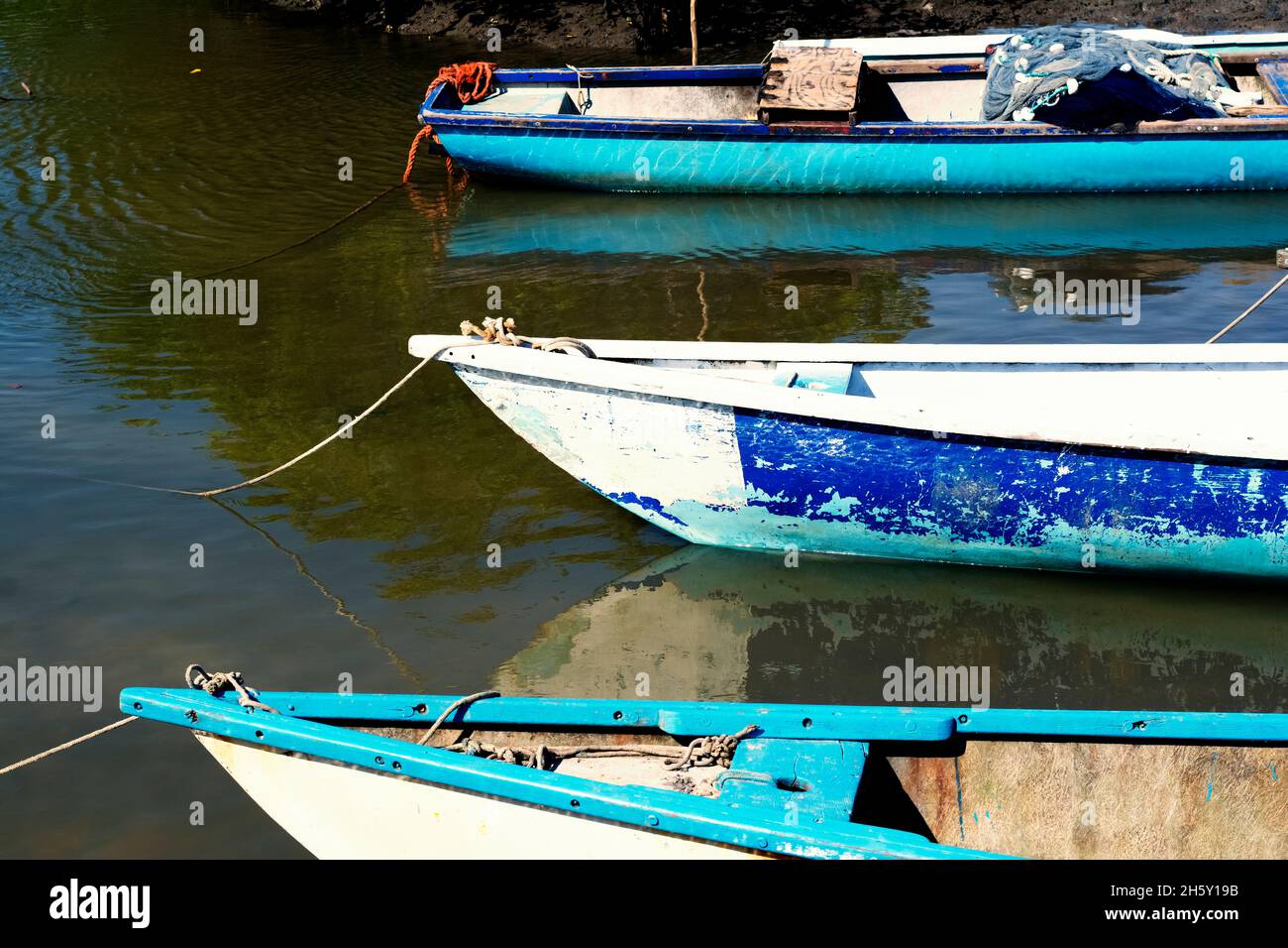 Canoes and colorful boats docked on the Paraguacu River in Saubara in ...