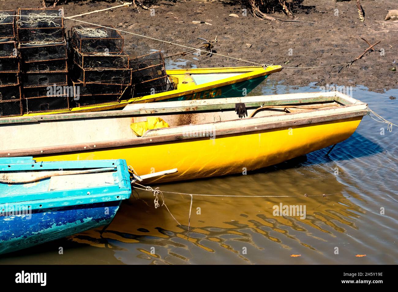 Canoes and colorful boats docked on the Paraguacu River in Saubara in ...