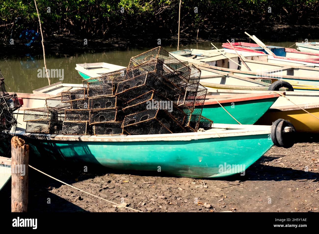 Canoes and colorful boats docked on the Paraguacu River in Saubara in ...