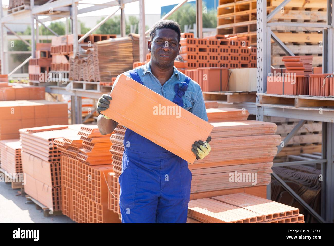 Clay man holding building hi-res stock photography and images - Alamy