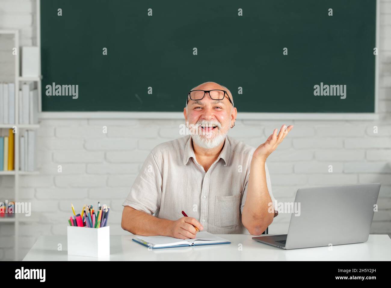 Excited senior teacher lecturer greeting students at workshop. Amazed ...