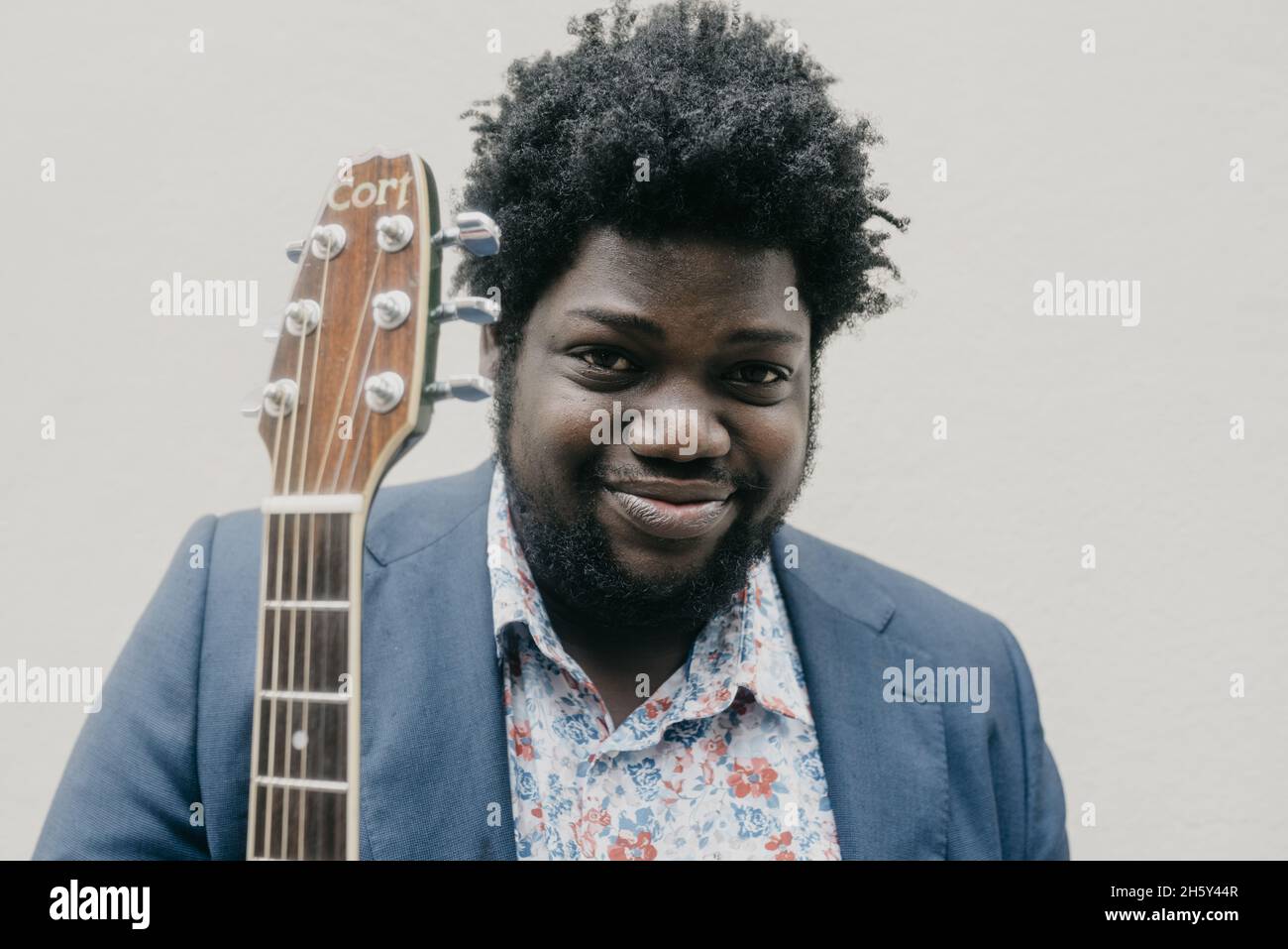 Shallow focus of a black man holding a guitar Stock Photo - Alamy