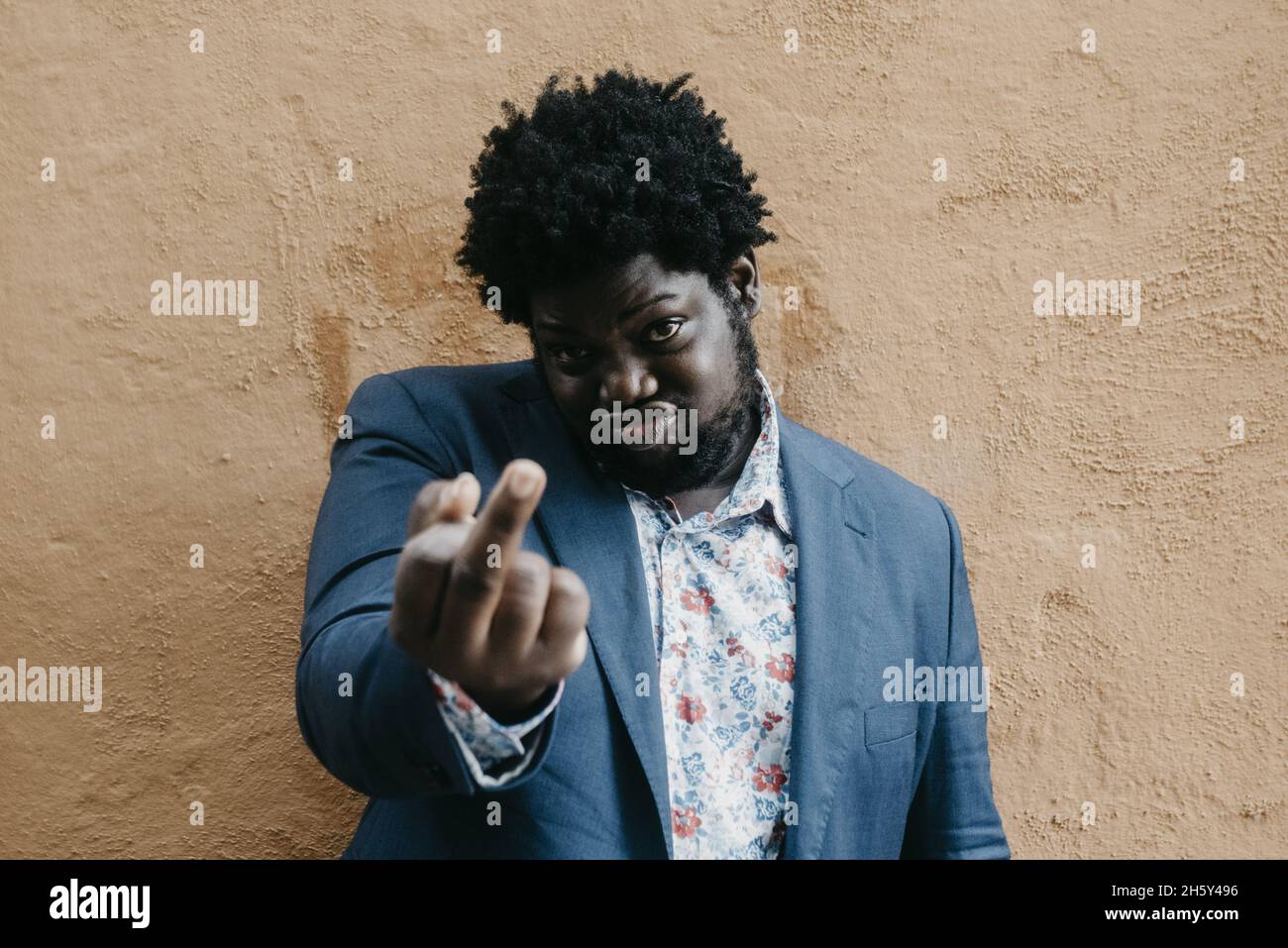 Shallow focus of a black man showing a middle finger Stock Photo - Alamy