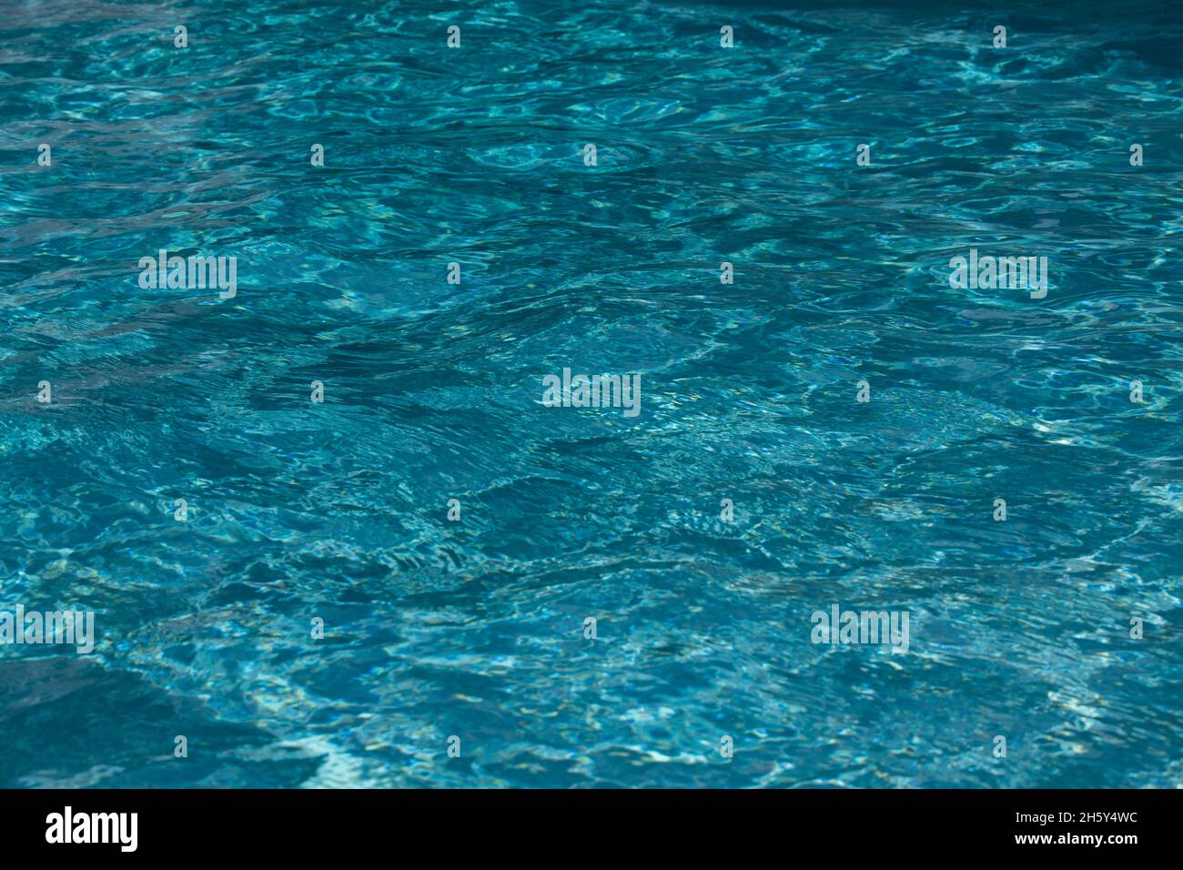 Abstract ripple wave and clear turquoise water surface in swimming pool ...