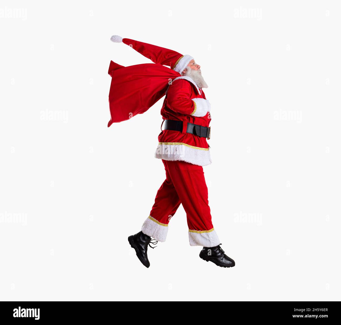 Santa Claus running on white background Stock Photo - Alamy