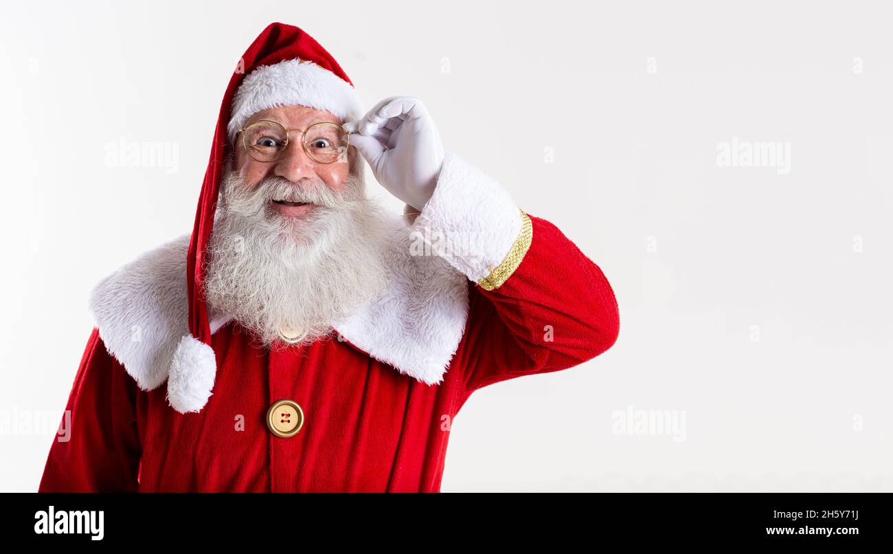 Santa Claus in eyeglasses is looking at camera and smiling, on white ...