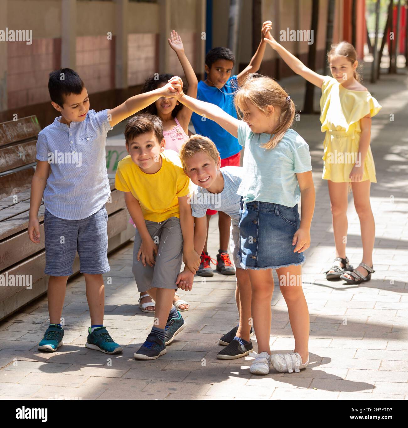 Energetic children play a game called trickle on the street Stock Photo ...