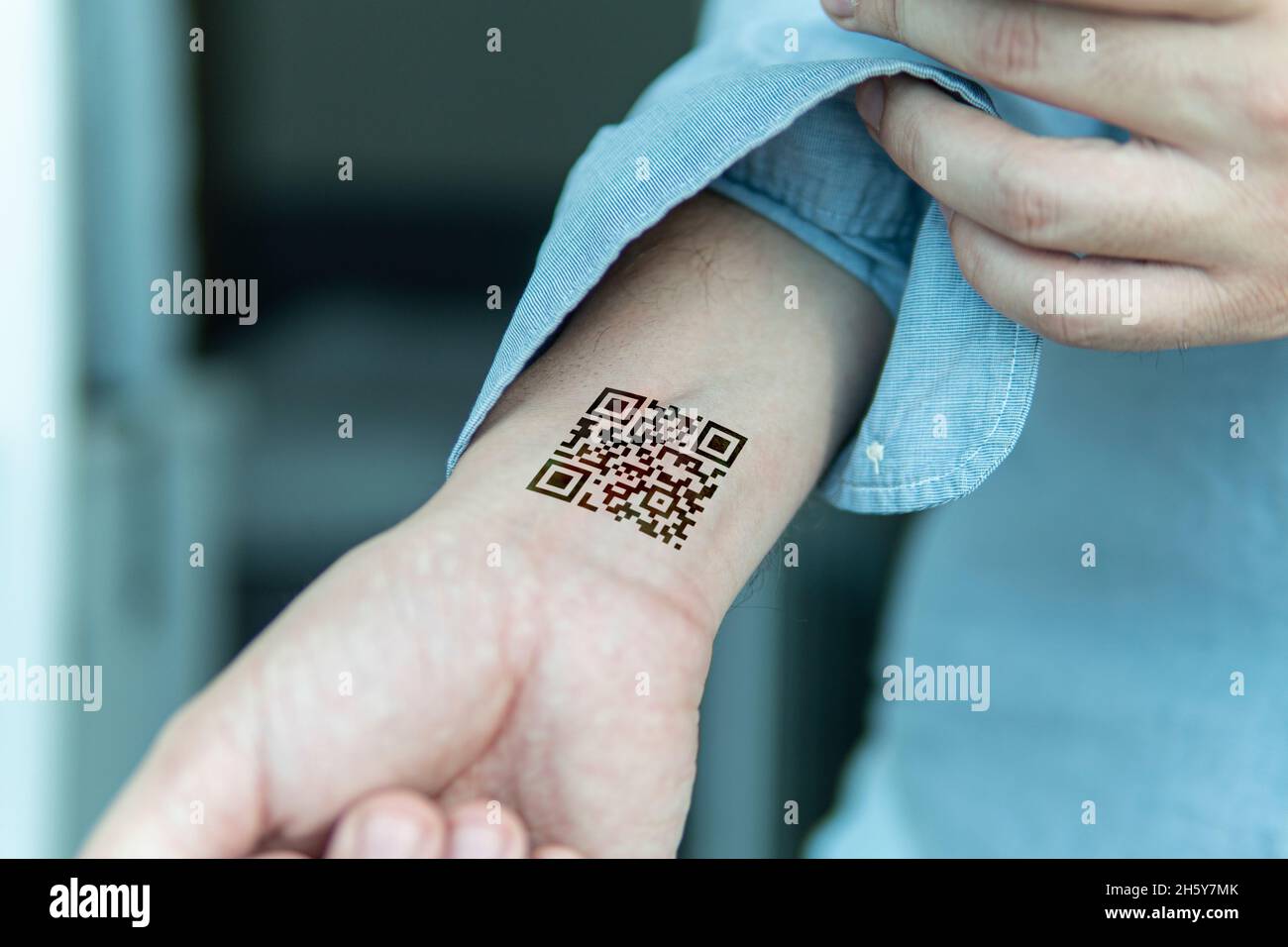 QR code on the person's wrist. The concept of chipping a person to ...